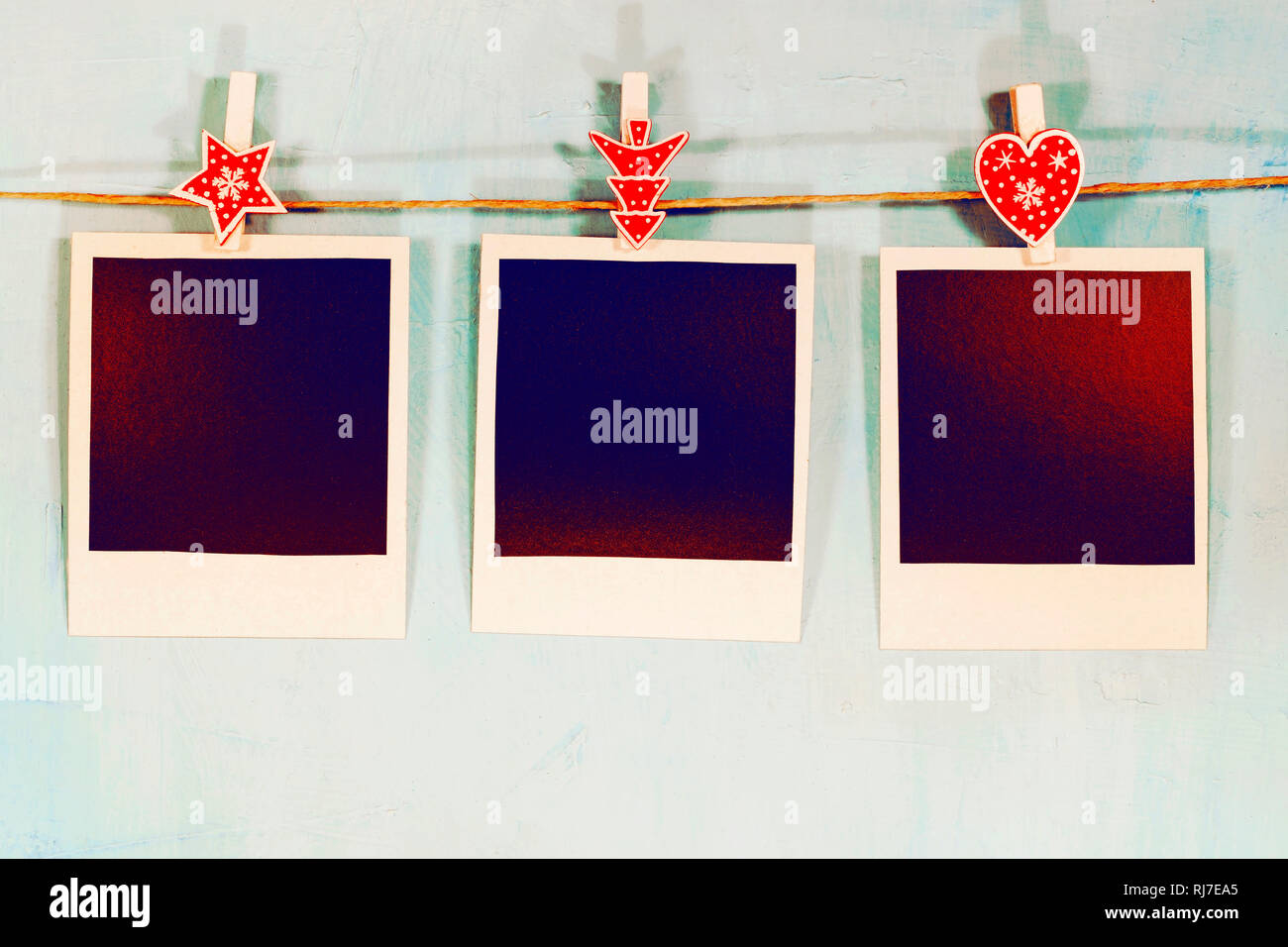 Blank instant images hanging on a string Stock Photo - Alamy