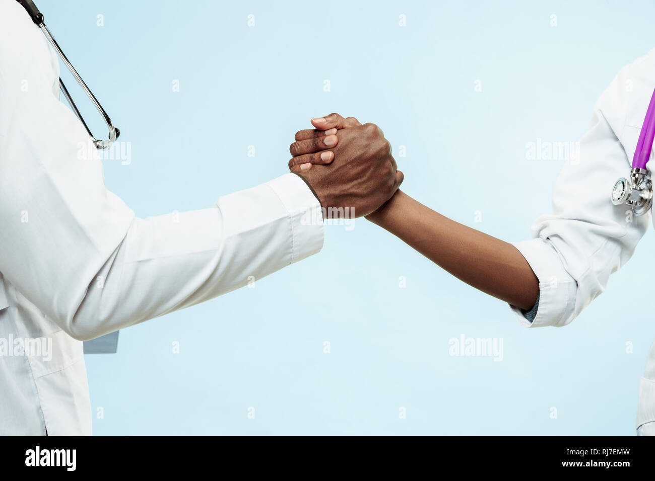 The female and male hands of afro american doctors at studio. The ...