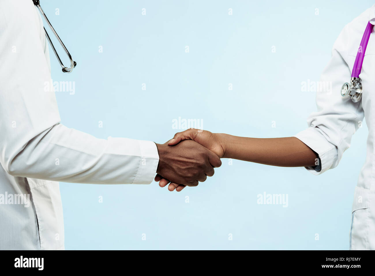 The female and male hands of afro american doctors at studio. The ...