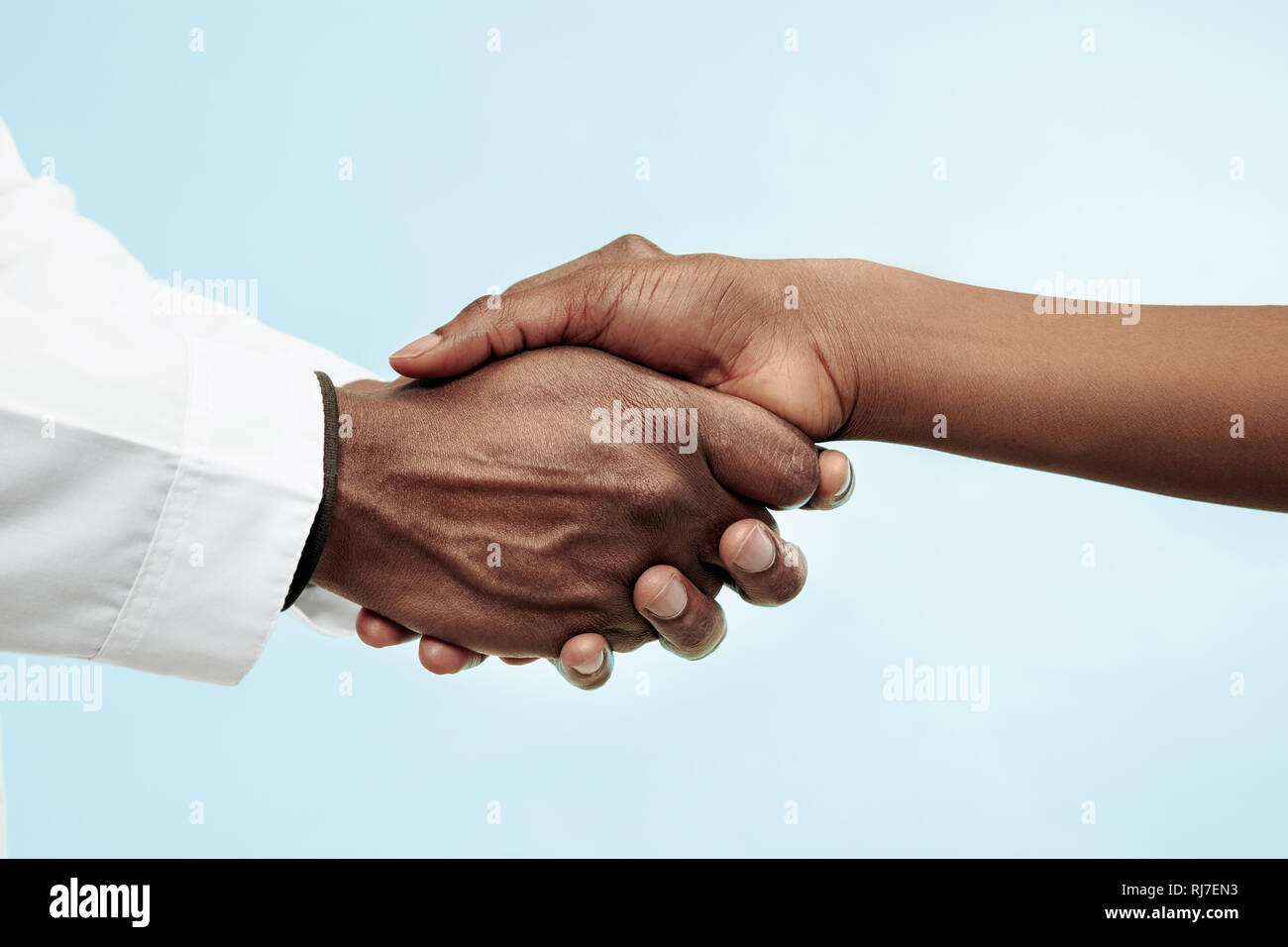 The female and male hands of afro american doctors at studio. The ...