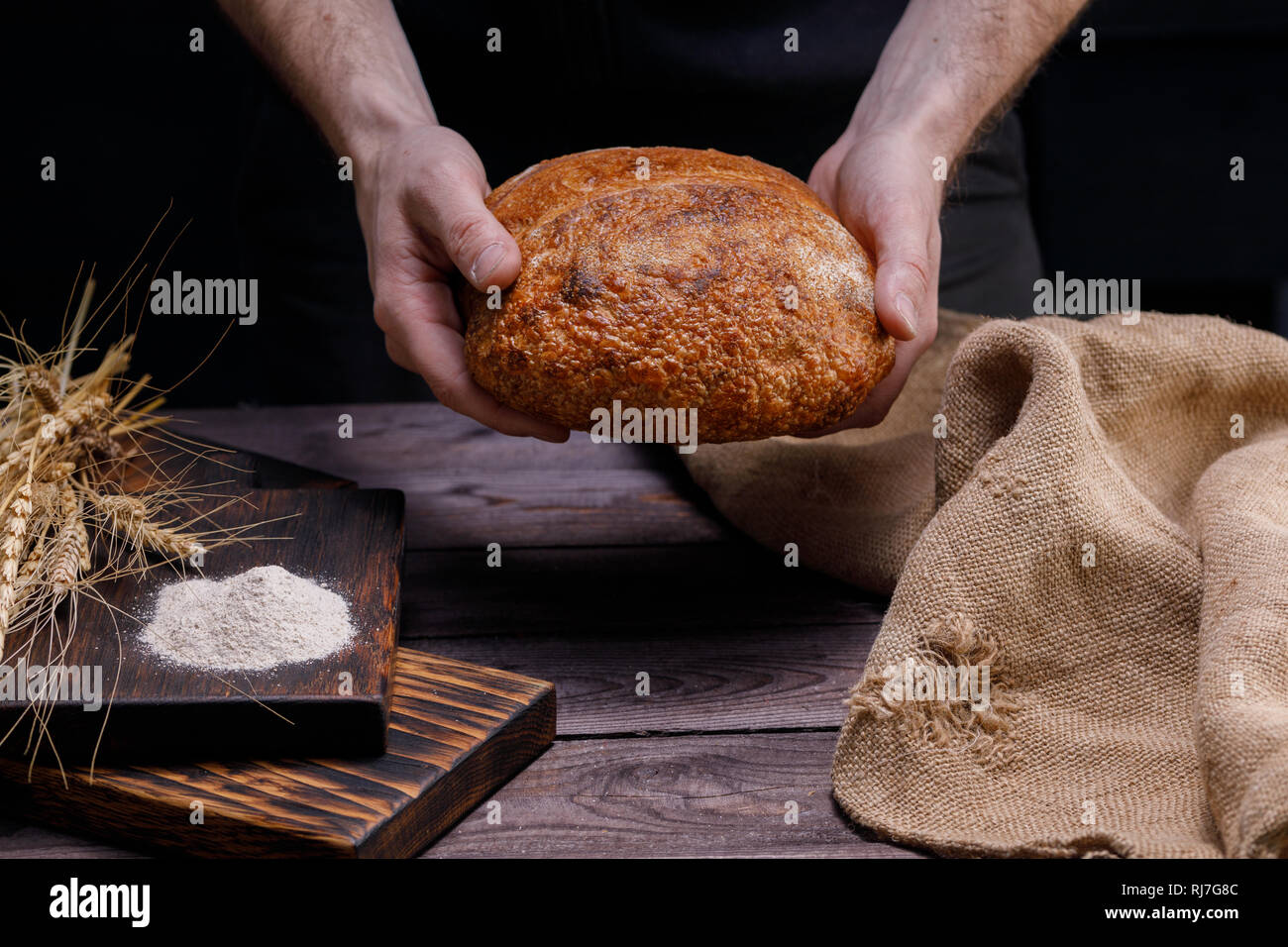Fresh artisan bread in the hands. The concept of healthy food and ...