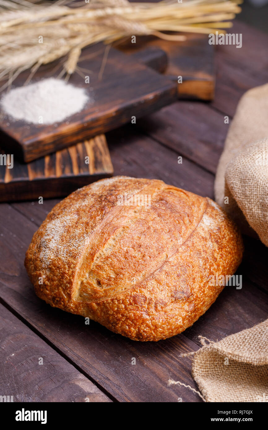 Round artisan bread. The concept of healthy food and traditional bakery ...