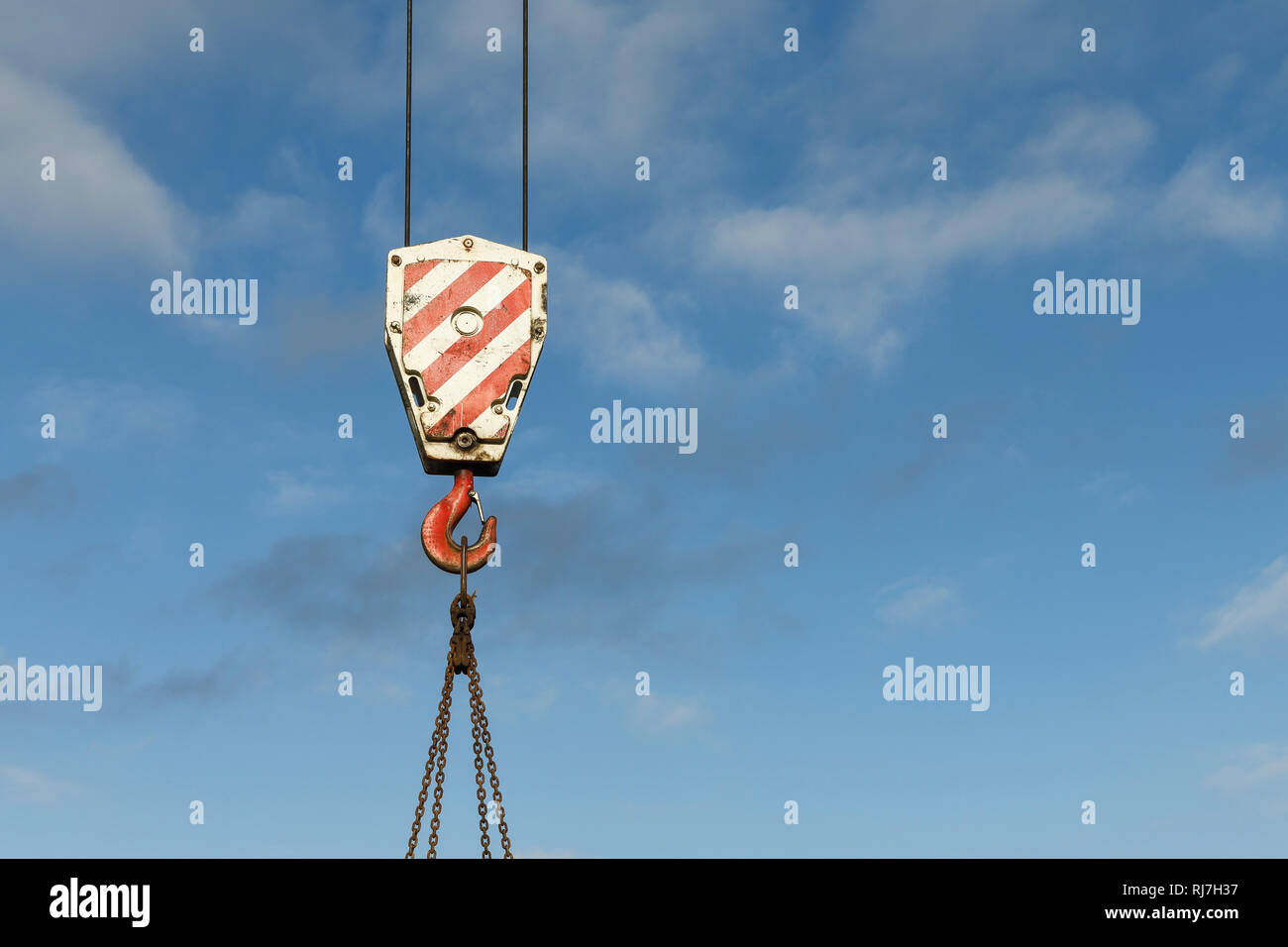 A heavy duty crane load block against a blue sky Stock Photo - Alamy