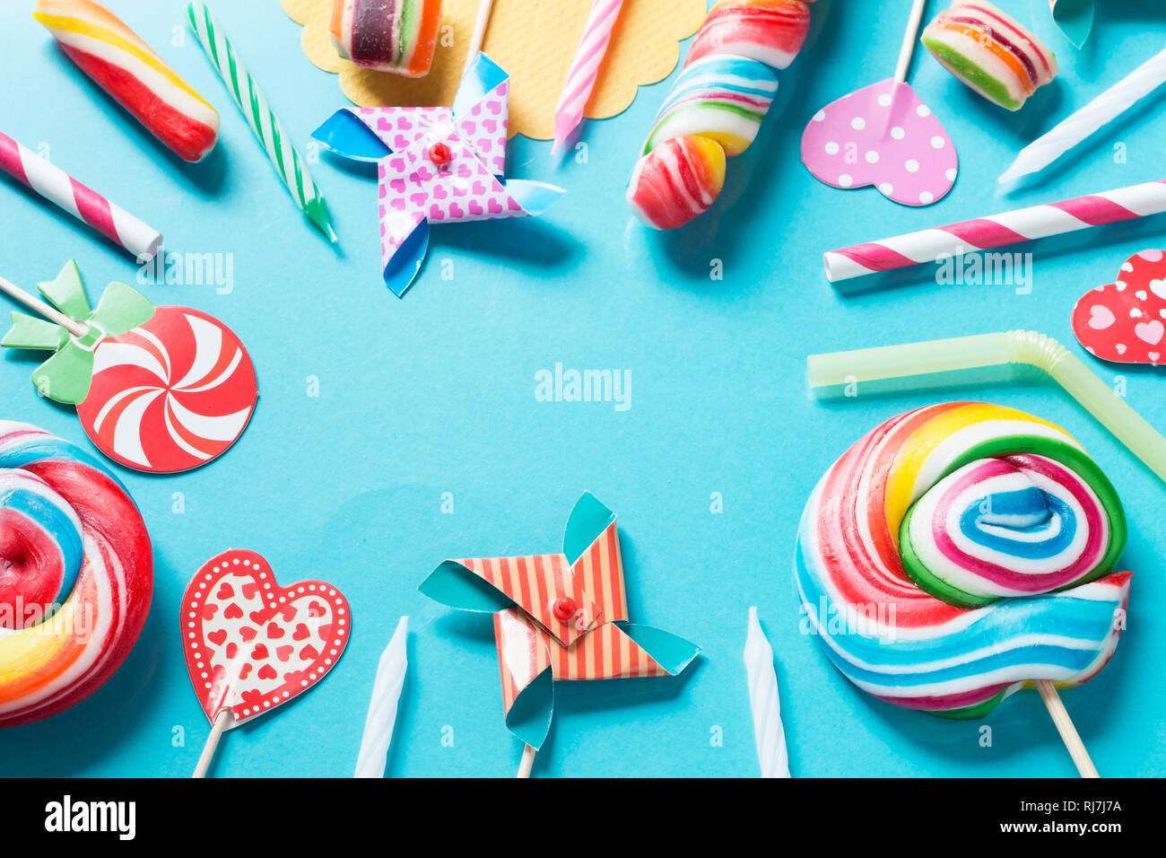 Birthday candies and accessories on blue background Stock Photo - Alamy