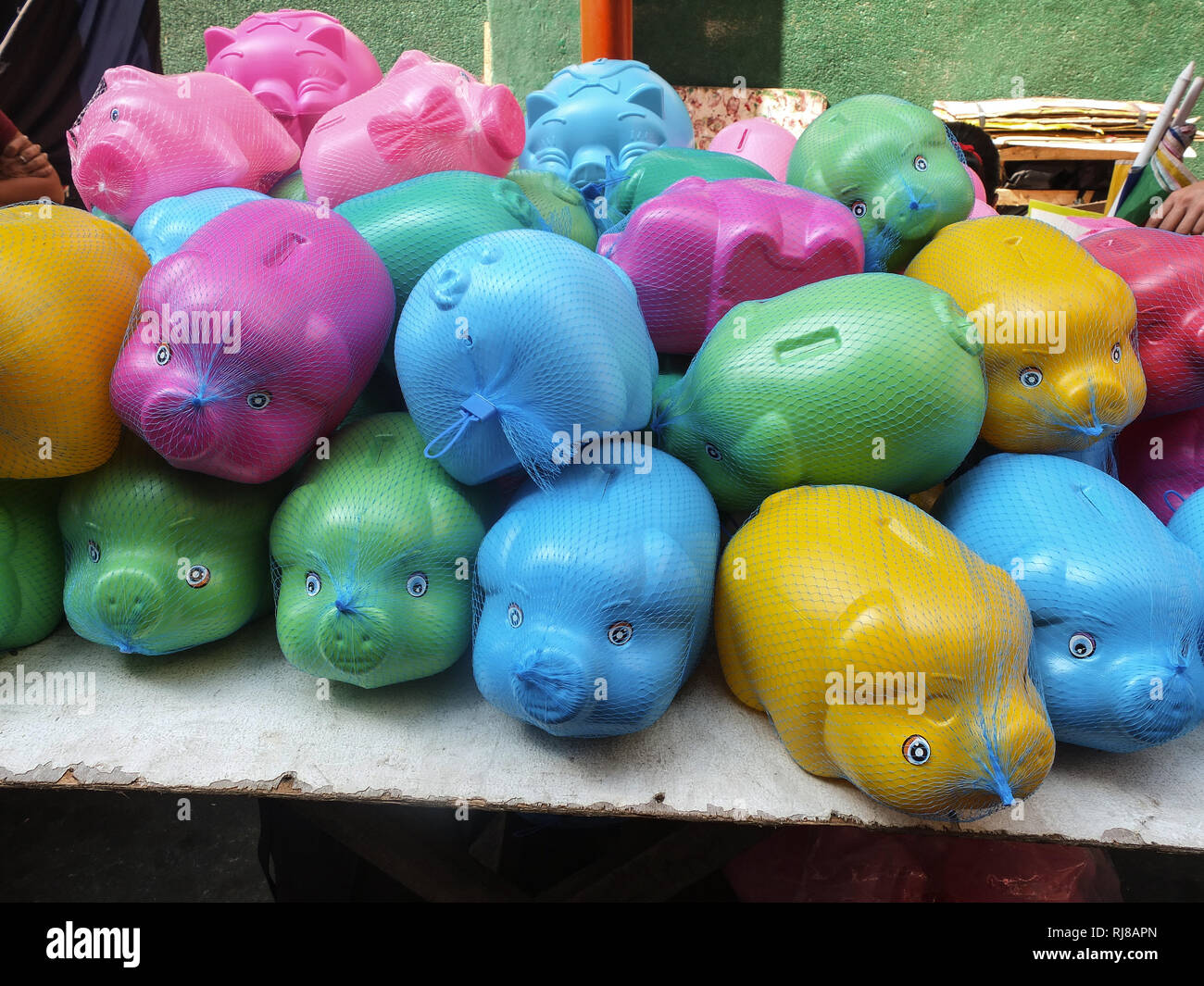 Different colors of plastic piggy banks are displayed in sidestreets in ...
