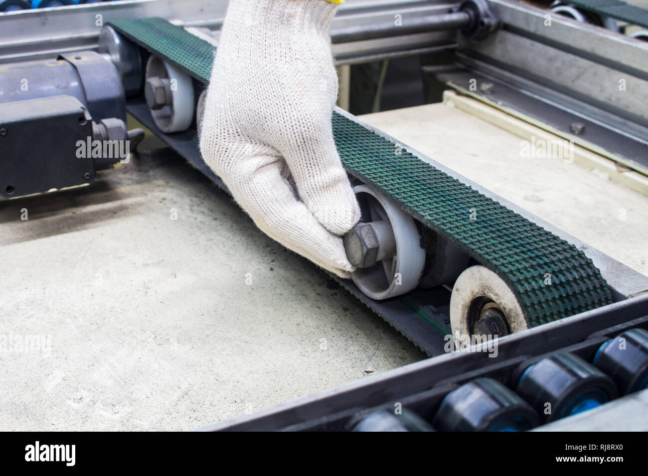 worker maintenance and repair conveyor belt in factory Stock Photo - Alamy