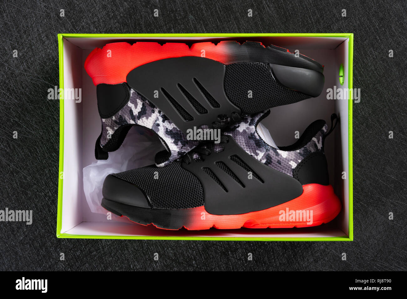 pair of red and black sporty shoes for kid in a box Stock Photo - Alamy