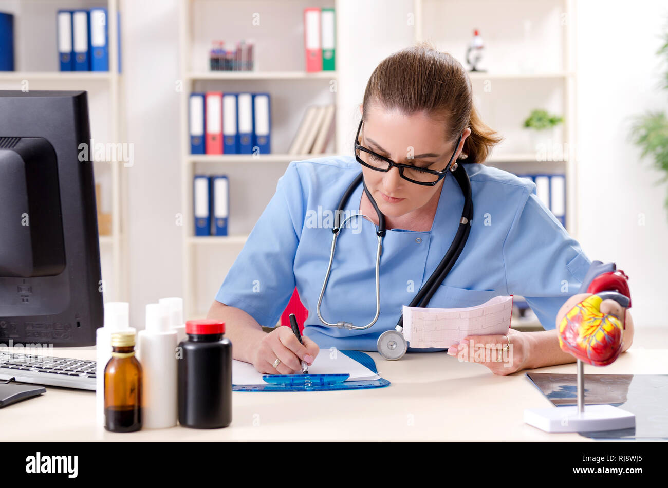 Female doctor cardiologist working in the clinic Stock Photo - Alamy