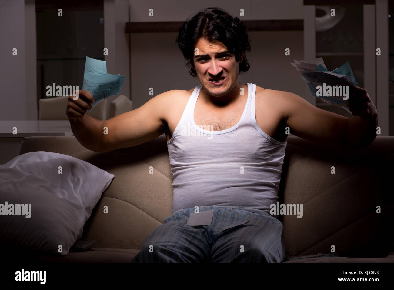 Young man calculating expences hi-res stock photography and images - Alamy