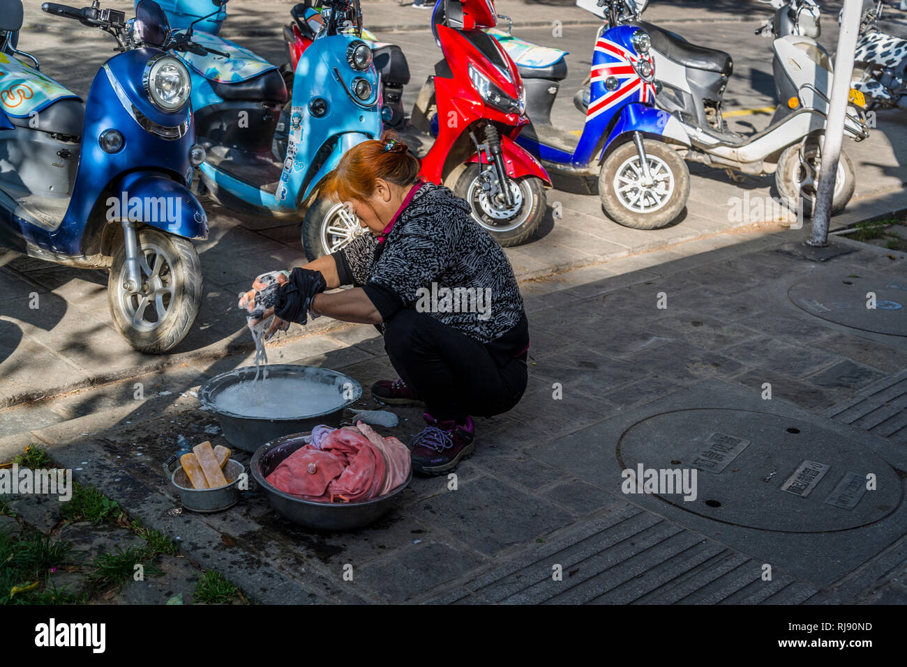 China woman washing clothes hi-res stock photography and images - Alamy