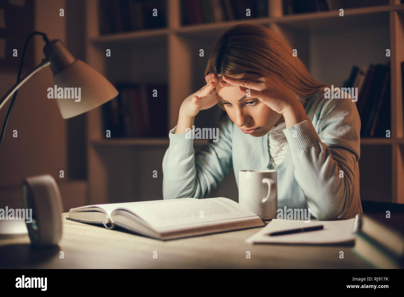 Tired student learning at home Stock Photo - Alamy