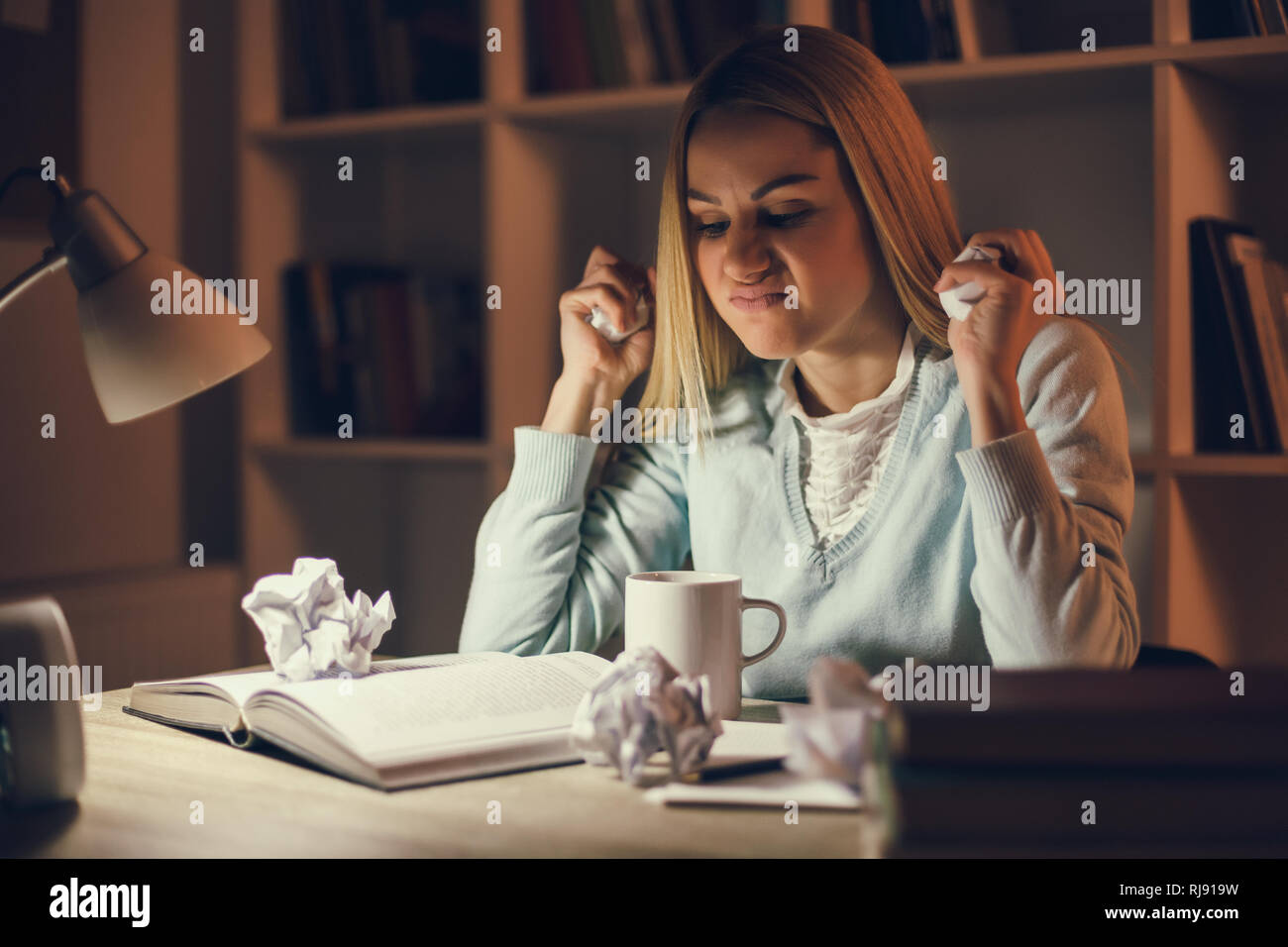 Student is angry, she has to learn at night Stock Photo - Alamy