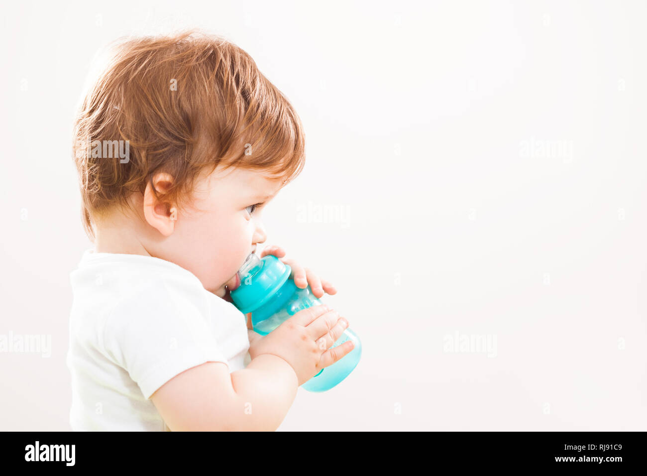 Baby boy drinking water Stock Photo - Alamy
