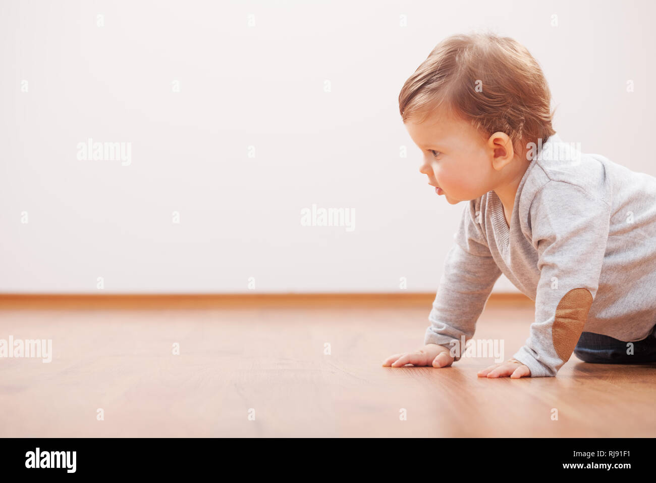 Cute baby boy crawling Stock Photo - Alamy
