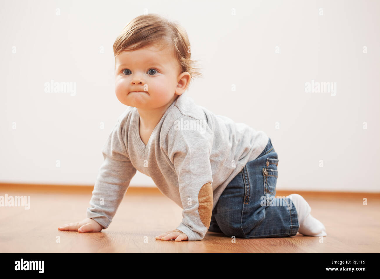 Cute baby boy crawling Stock Photo - Alamy