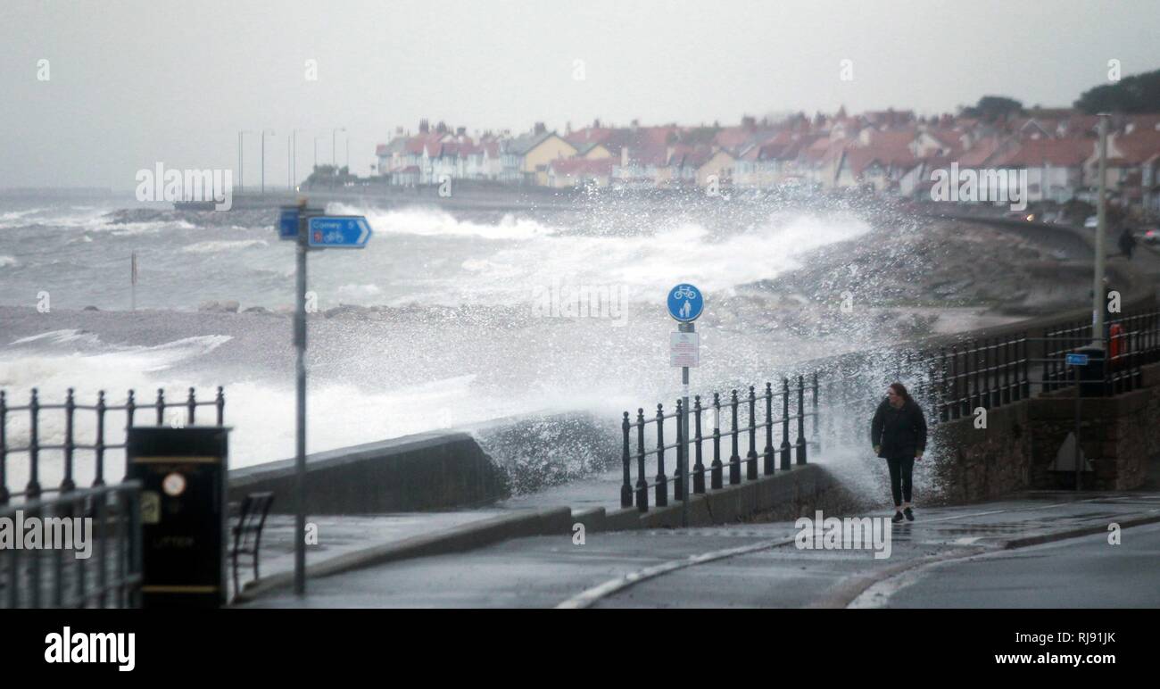 Waves overtopping the sea wall in Penhryn Bay soon before high tide ...