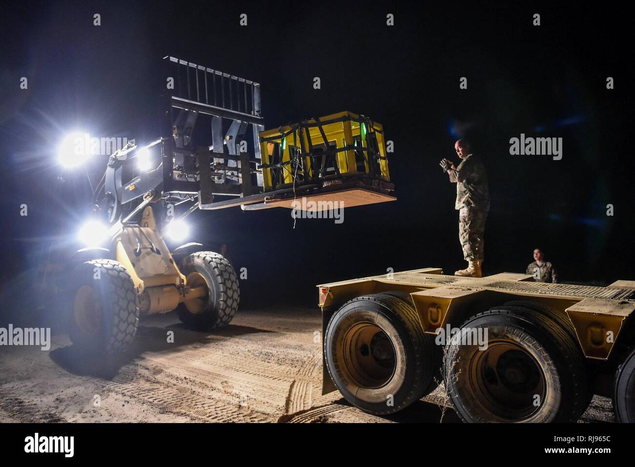 Air Commandos move cargo bundles onto a truck during Task Force ...