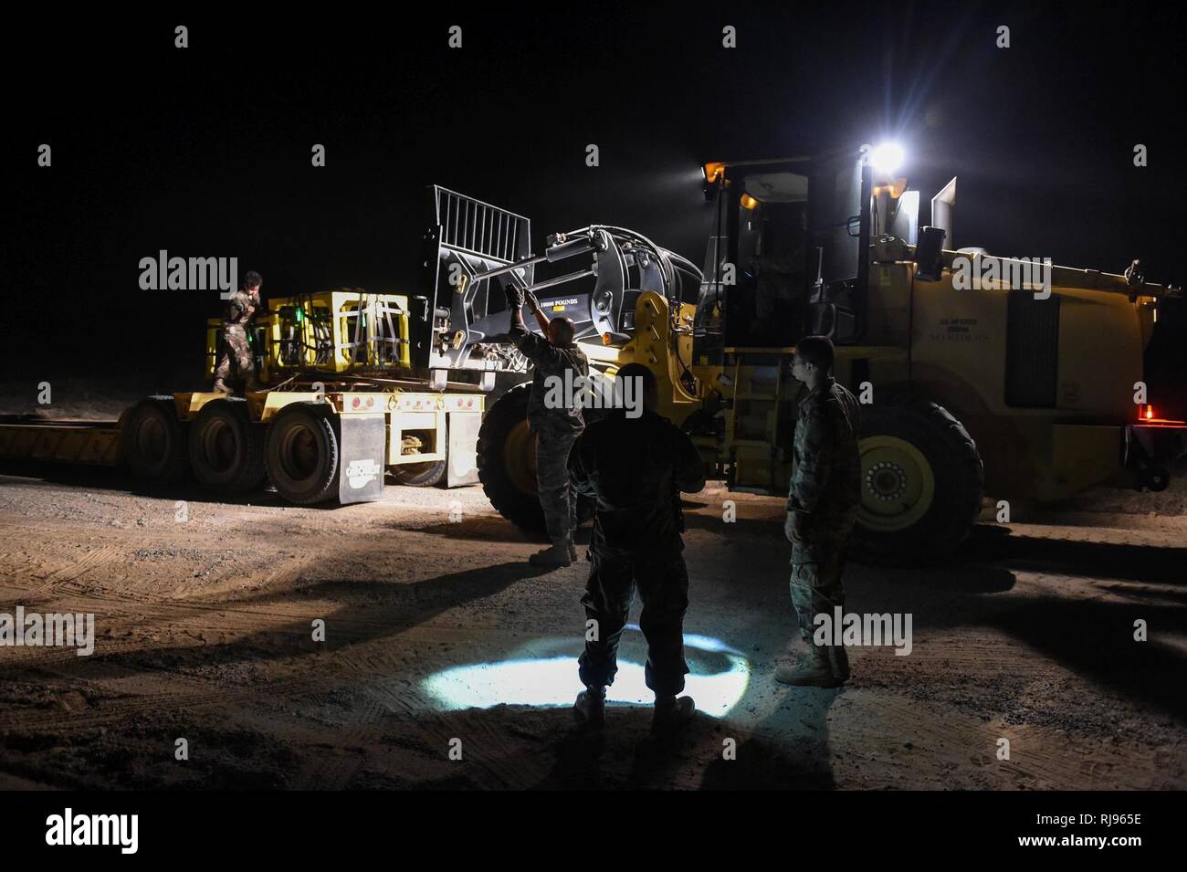 Air Commandos move cargo bundles onto a truck during Task Force ...