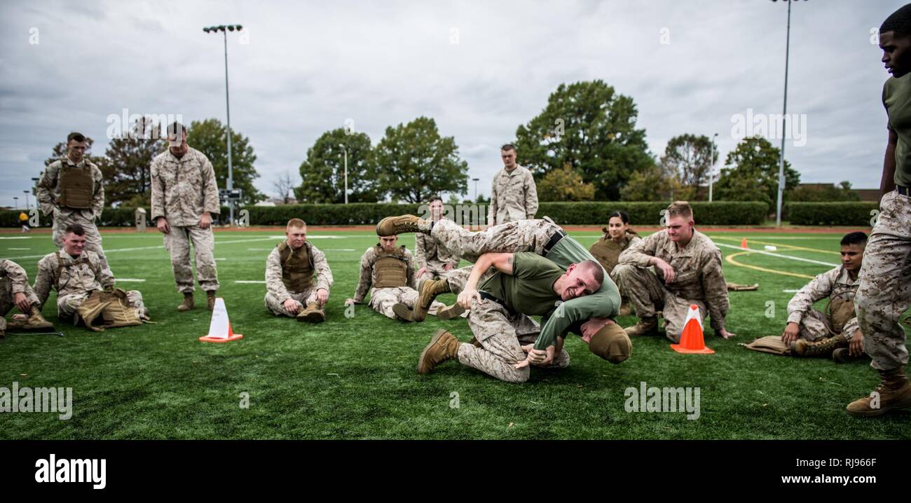 Marines watch as the instructors demonstrate the ground grappling ...