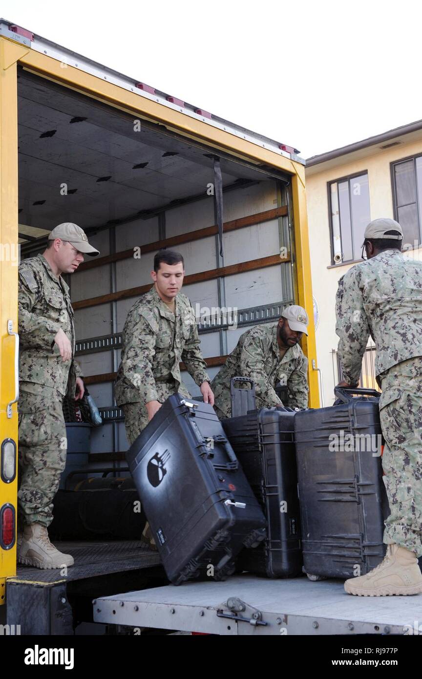 U.S. Navy Sailors and Canadian military forces load gear in preparation ...