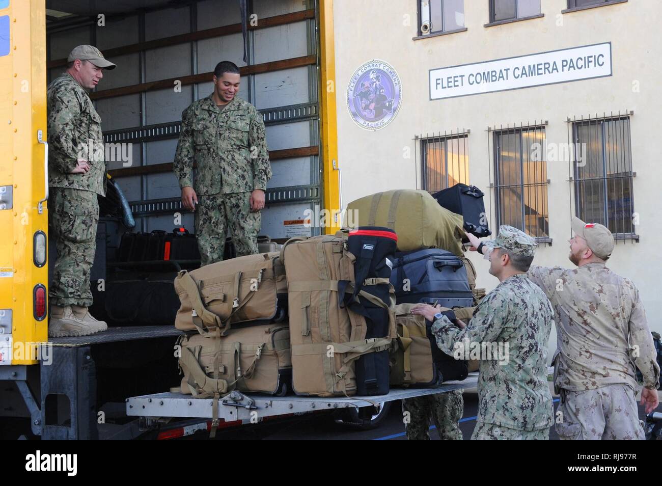 U.S. Navy Sailors and Canadian military forces load gear in preparation ...