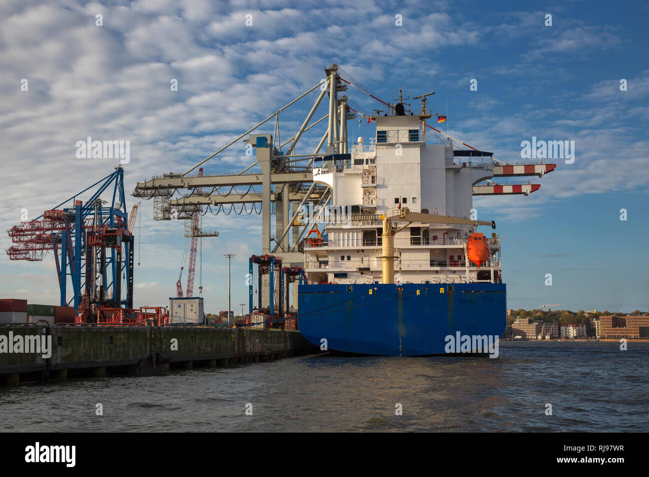 Discharge of a ship at the quay in the harbor Stock Photo - Alamy