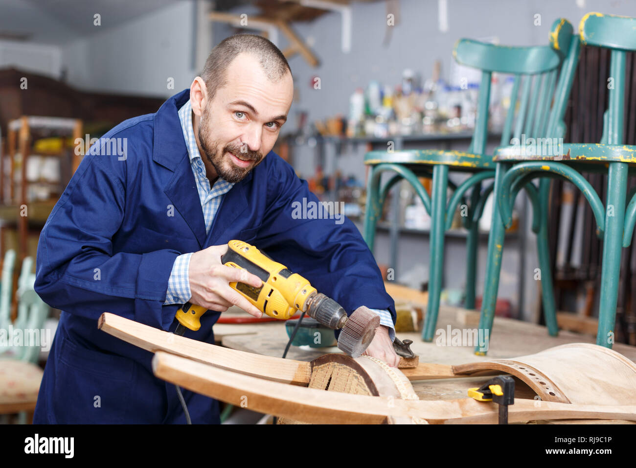 Professional furniture restorer in process of renovation vintage ...