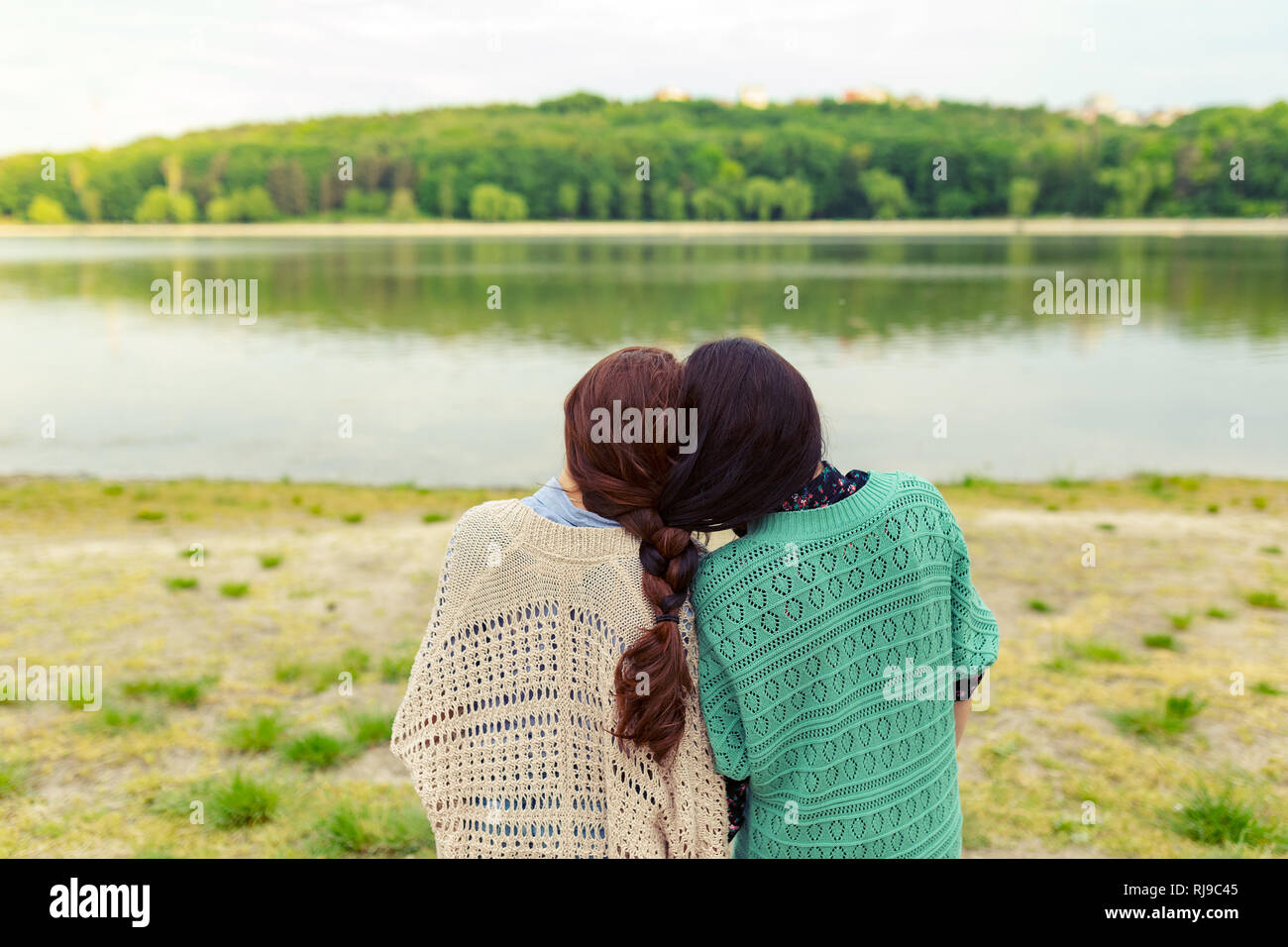 Back view sisters watching beautiful landscape on the horizon with hair ...