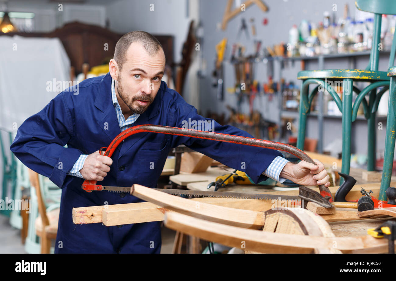 Craftsman in process of creation wooden furniture in workshop Stock ...