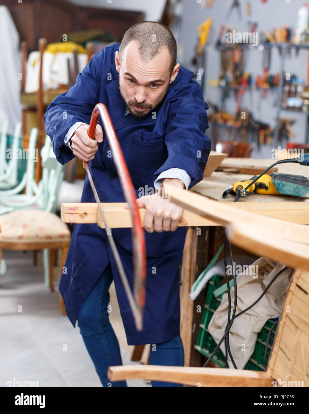 Carpenter using tools for creating wooden furniture in studio Stock ...