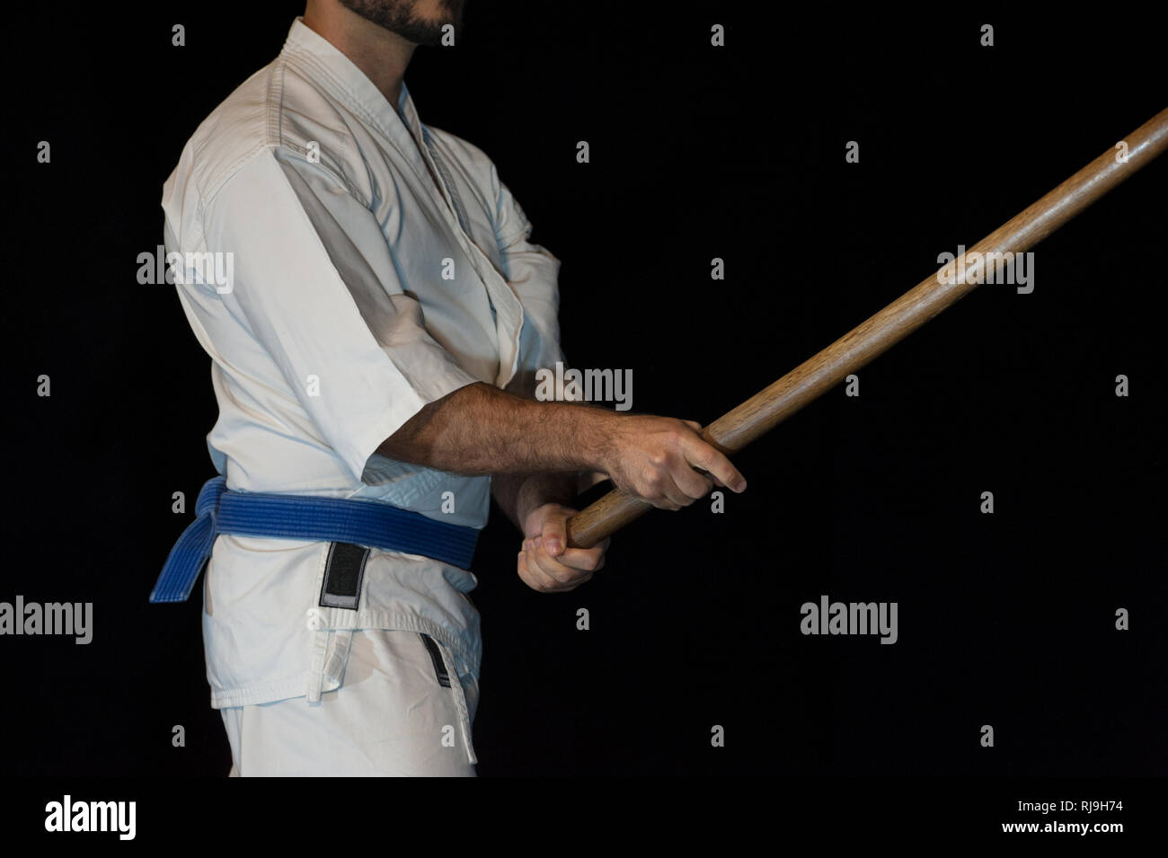 Aikido fighter with his wood stick during a combat Stock Photo - Alamy