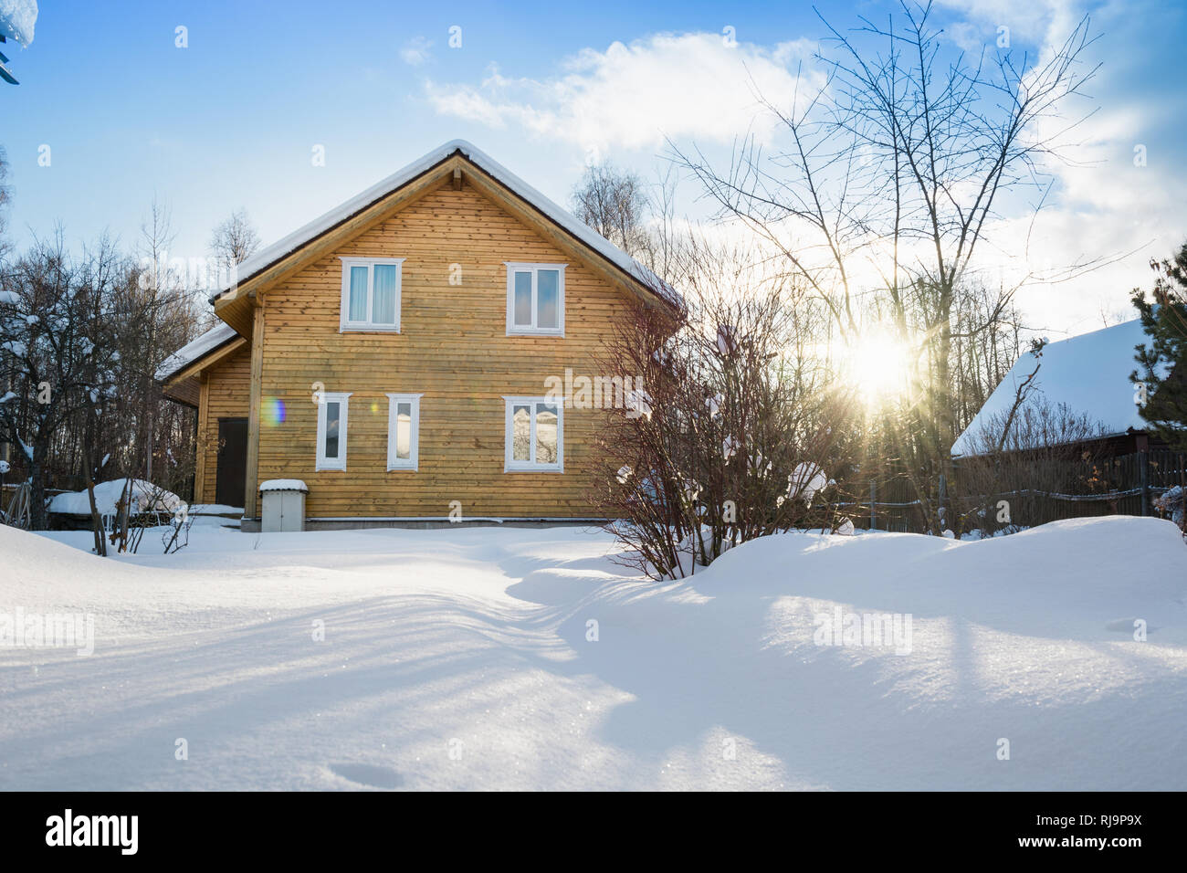 Wooden house in the russian countryside in winter. There is two-story ...
