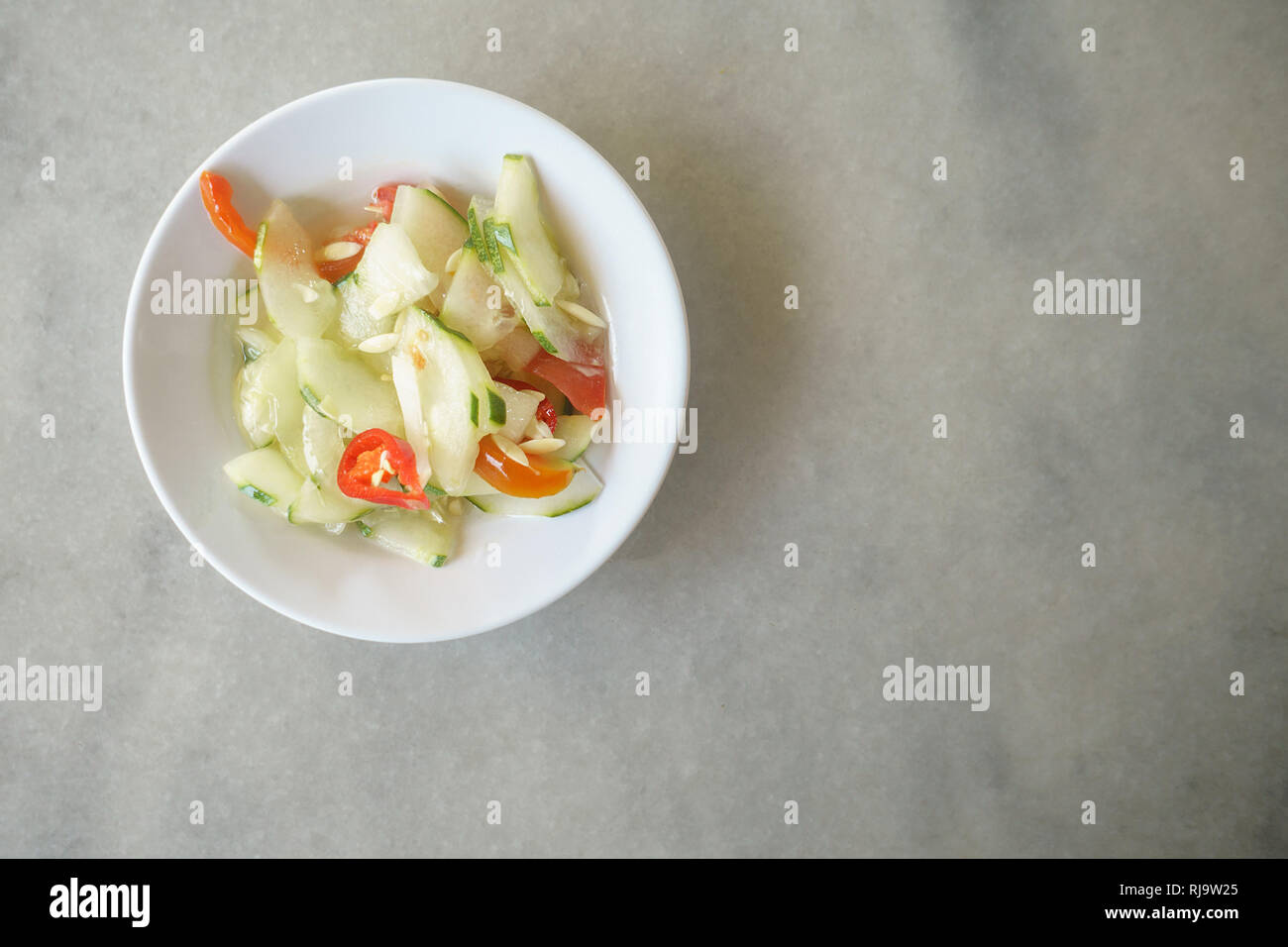 Malaysian street food acar timun or cucumber pickle on table setup ...