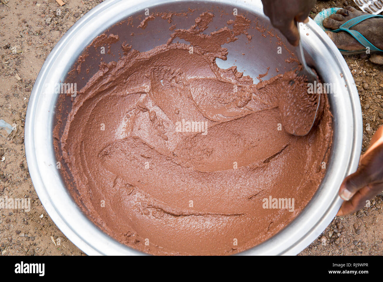 Baribsi village, Yako, Burkina Faso, 30th November 2016; mixing ground ...