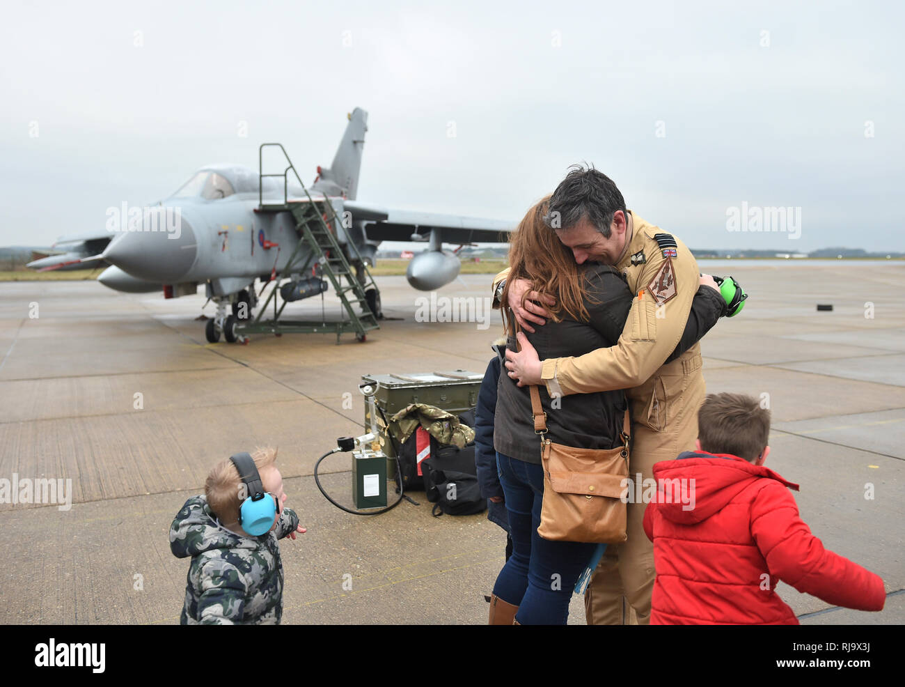 Officer Commanding IX Squadron Wing Commander James Heeps hugs his wife ...