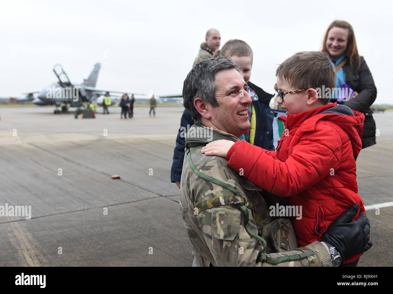 Officer Commanding IX Squadron Wing Commander James Heeps hugs his son ...