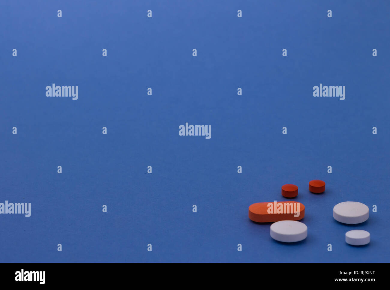 Pills of colors on neutral background. Legal drugs from the ...