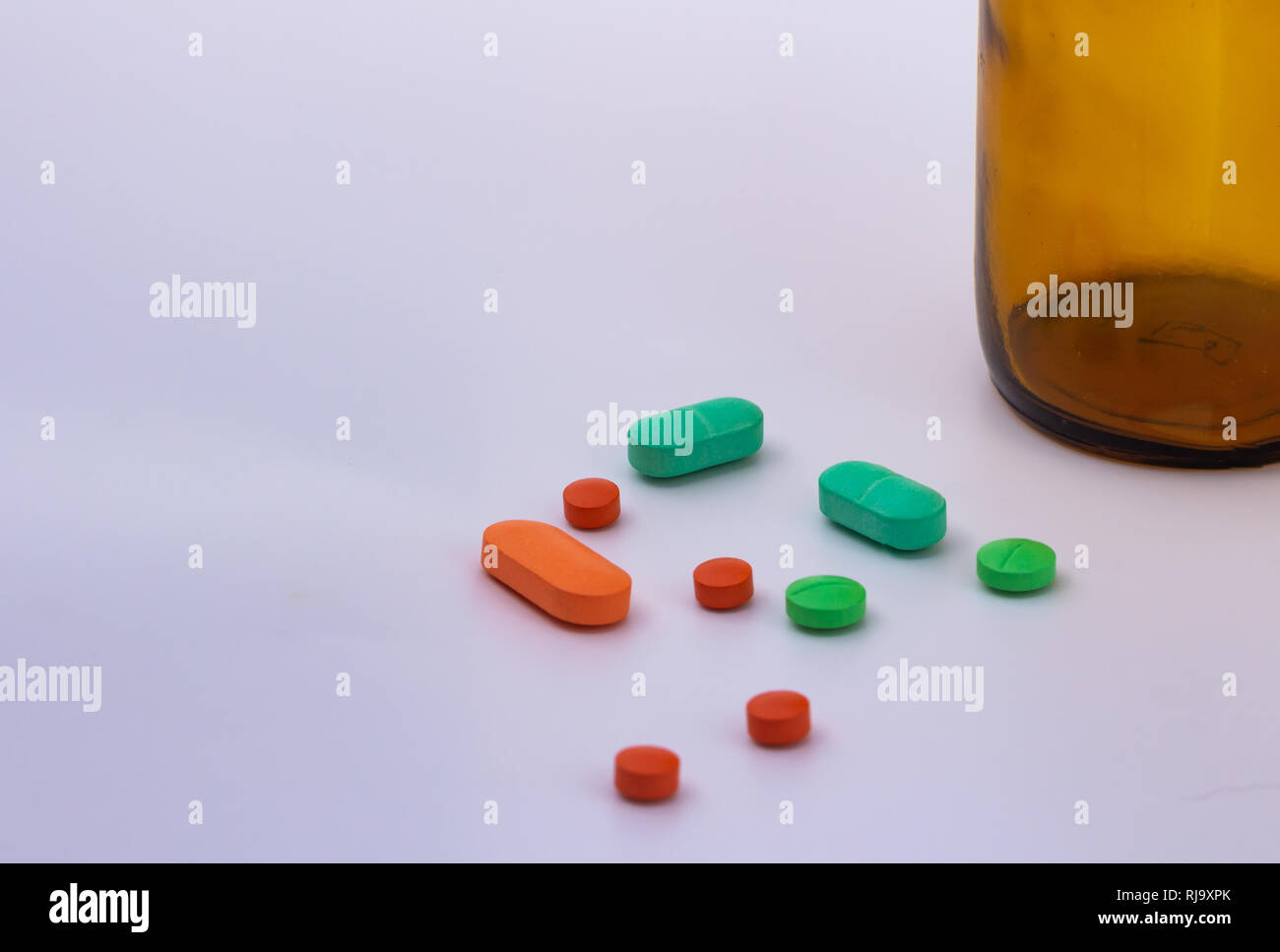 Pills of colors on neutral background. Legal drugs from the ...