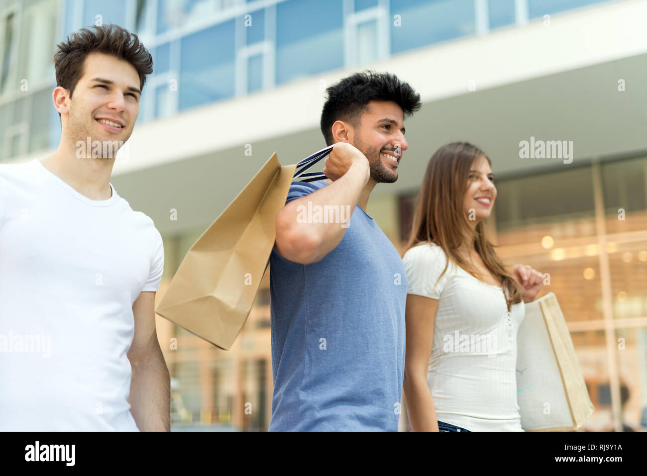 Friends shopping together in a city Stock Photo - Alamy