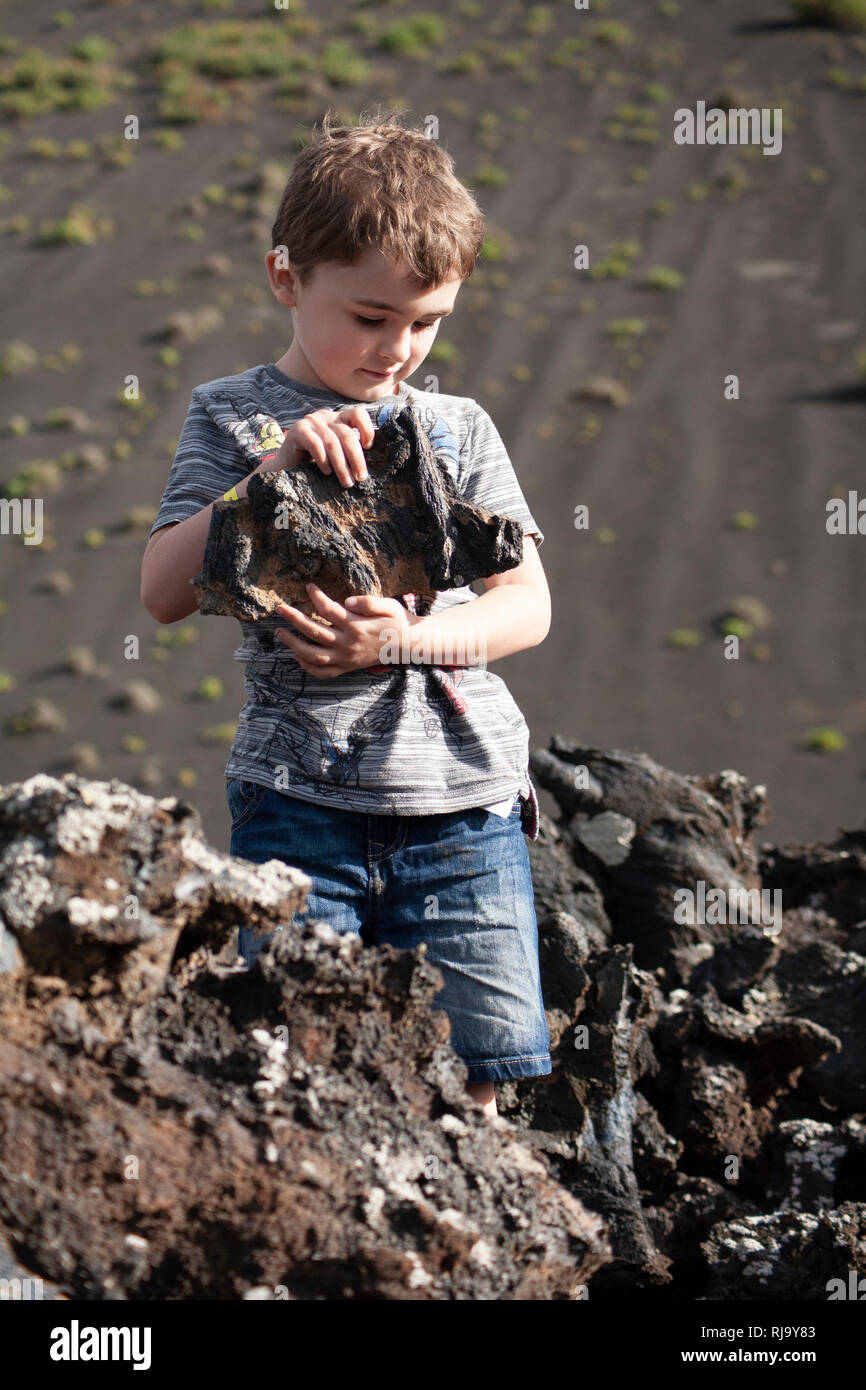 Young boy collecting rocks Stock Photo - Alamy