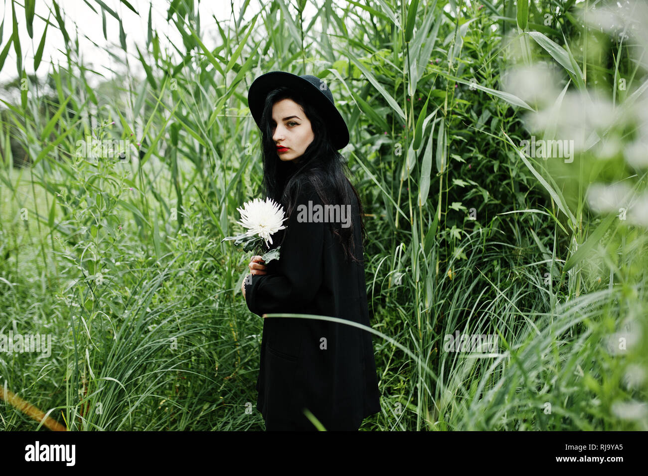 Sensual girl all in black, red lips and hat. Goth dramatic woman on ...