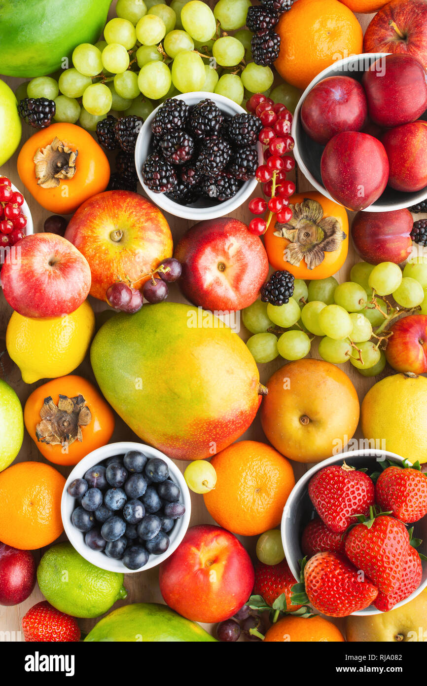 Healthy fruit background filled with strawberries raspberries oranges ...