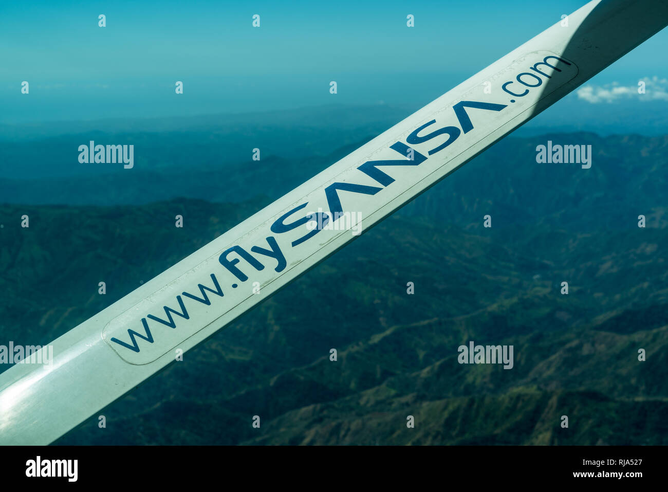 A Cessna Grand Caravan operated by Sansa Airlines is flying over a ...