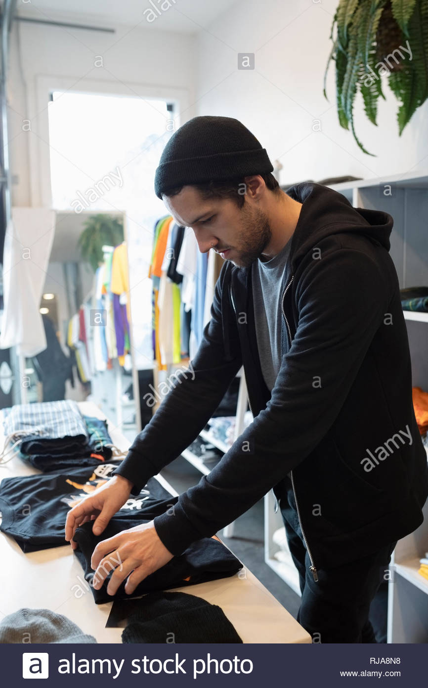 Male business owner arranging display in menswear clothing shop Stock ...