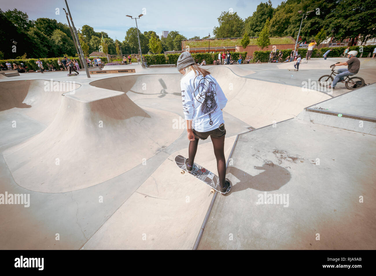A teenage girl prepares to skate down a ramp at The Level Skatepark in ...