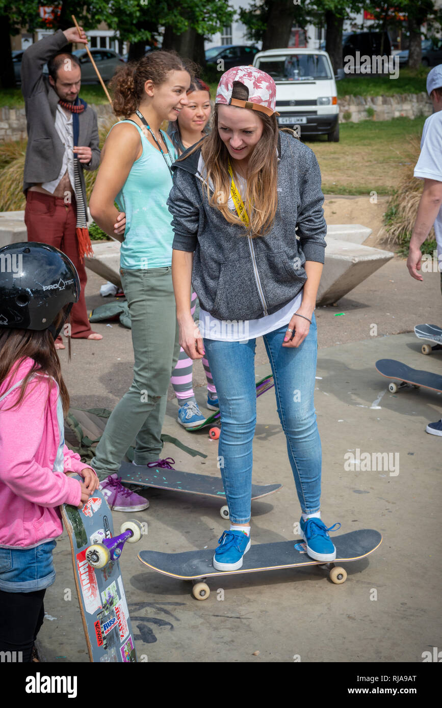 A female teenage skater teaches a young girl how to skate at The Level ...