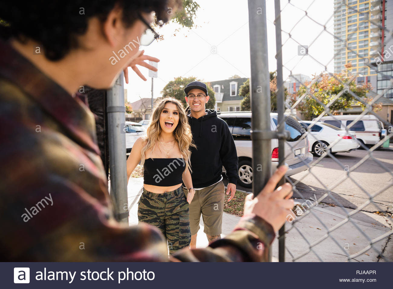 People talking over fence hi-res stock photography and images - Alamy