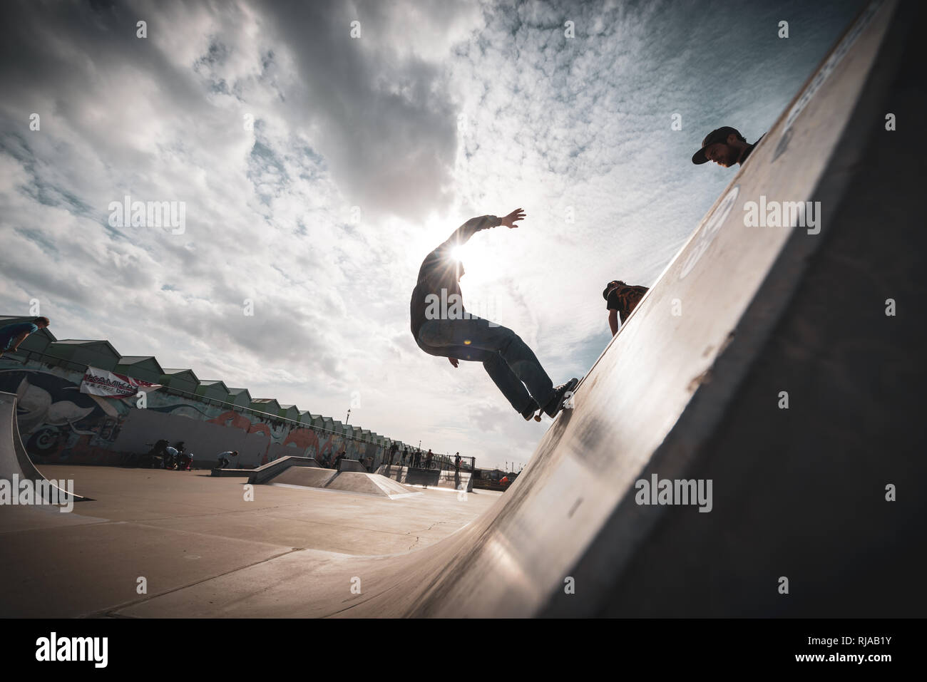 A man skating performs a trick on a ramp at the Hove Lagoon Skatepark ...