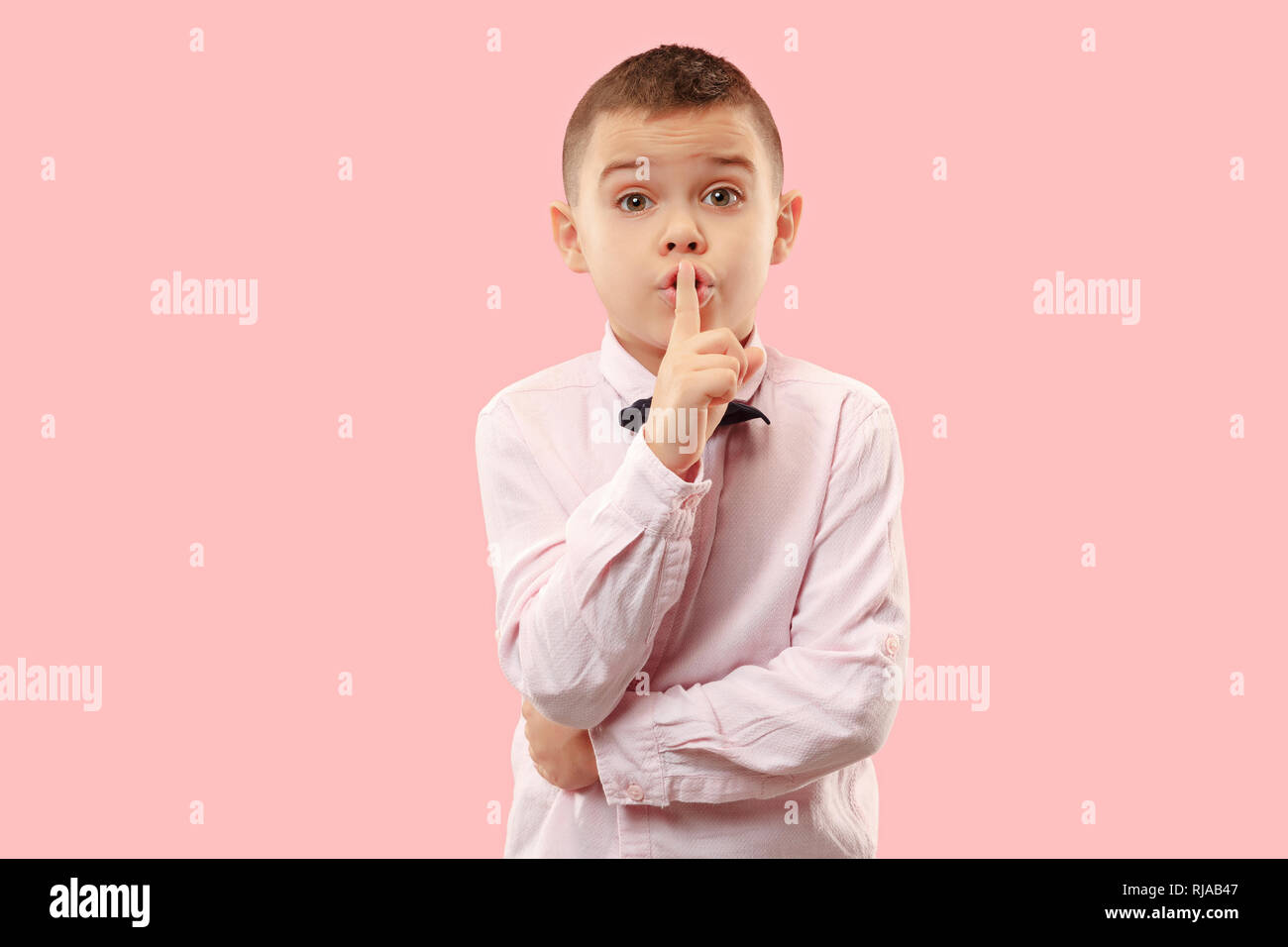 Secret, gossip concept. Teen boy whispering a secret behind his hand ...