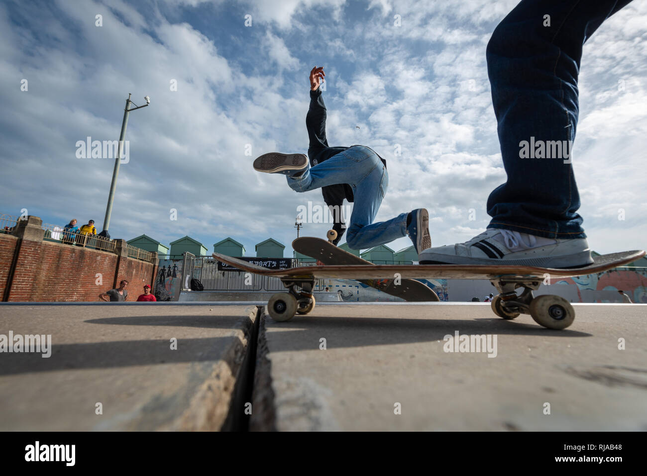 A man skating falls and flies through the air as he tries to perform a ...